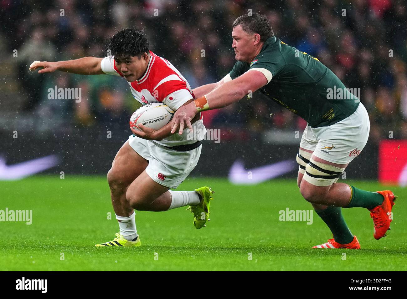 Japan's Kenji Sato is tackled by South Africa's Jasper Wiese during the ...