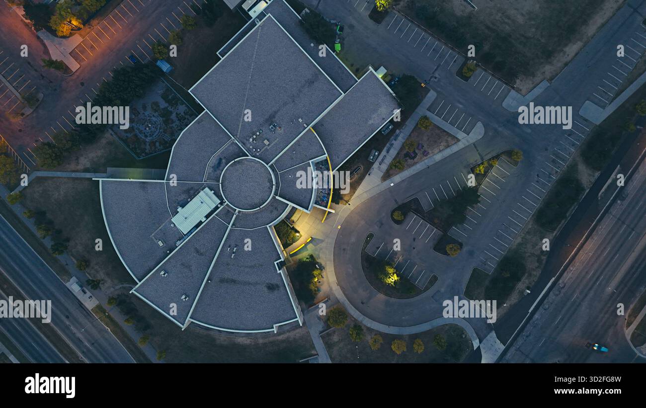 Overhead aerial view of a modern circular school building and parking ...