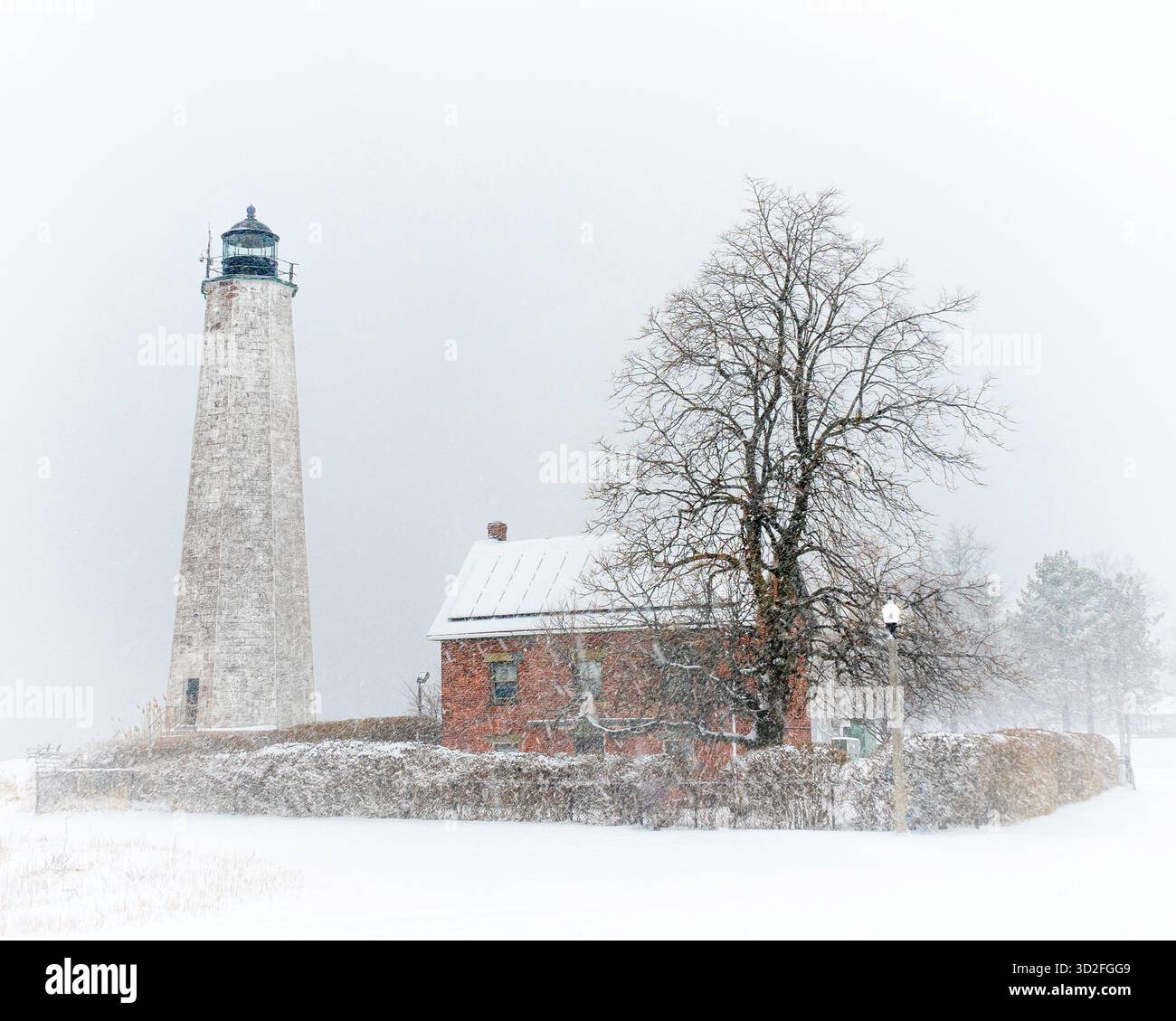 Fresh winter snow falls at Five Mile Point Lighthouse creating a winter ...