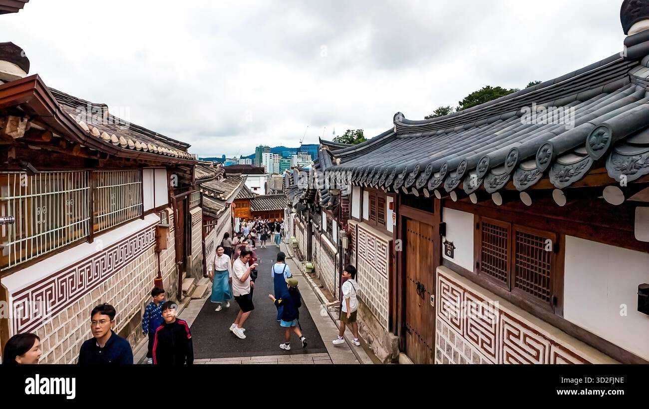 SEOUL, SOUTH KOREA - OCTOBER 11, 2025 - People walking along a narrow ...