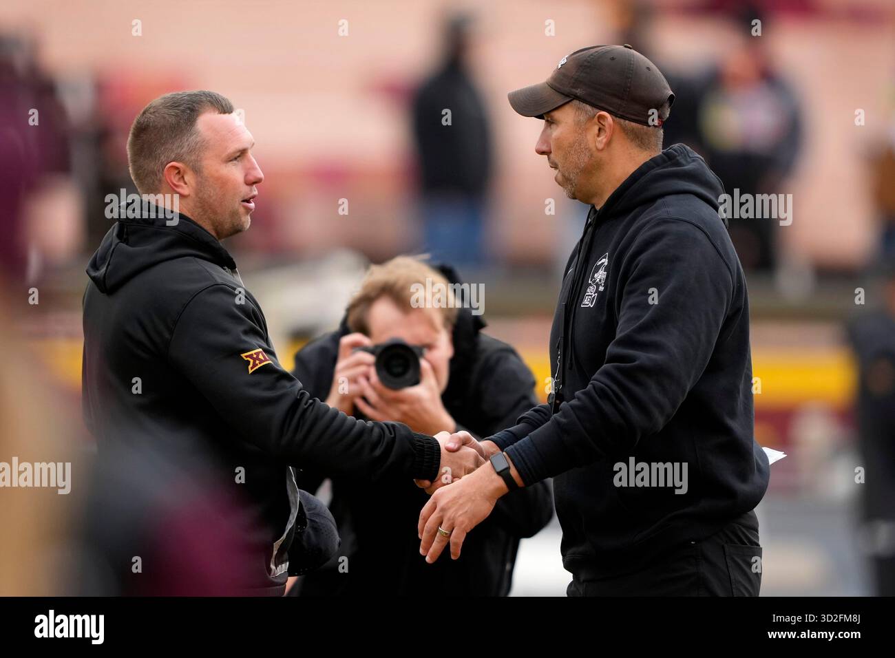 Arizona State head coach Kenny Dillingham, left, greets Iowa State head ...