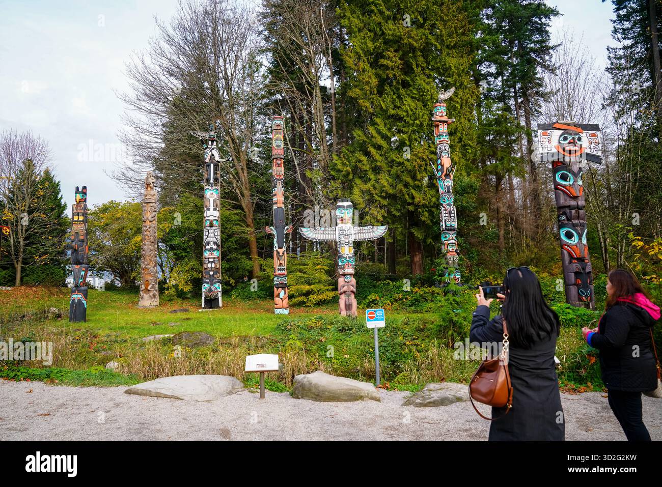 Visitors photograph the totem pole display at Brockton Point in Stanley ...