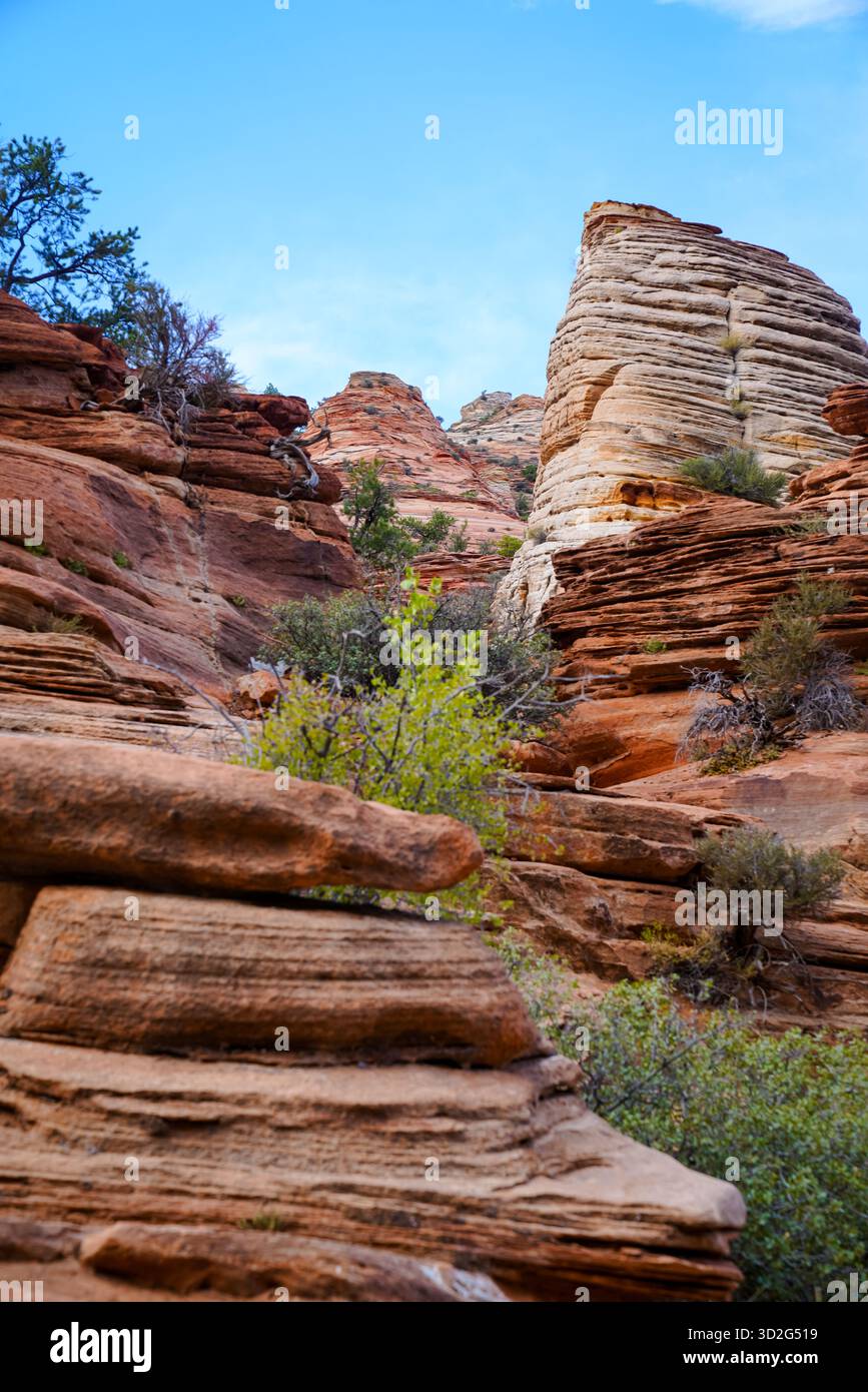 Layered sandstone formations stack in sculpted shapes along the rugged ...
