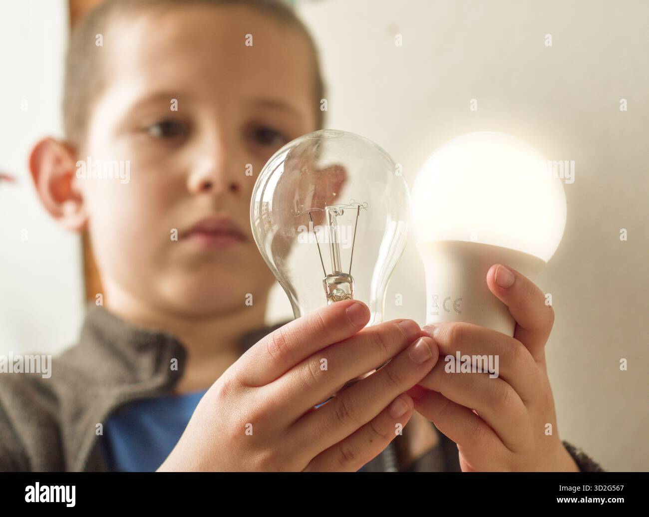 Boy holding light bulbs hi-res stock photography and images - Alamy