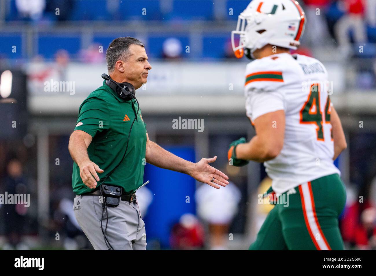 Miami head coach Mario Cristobal greets players as they come off the ...