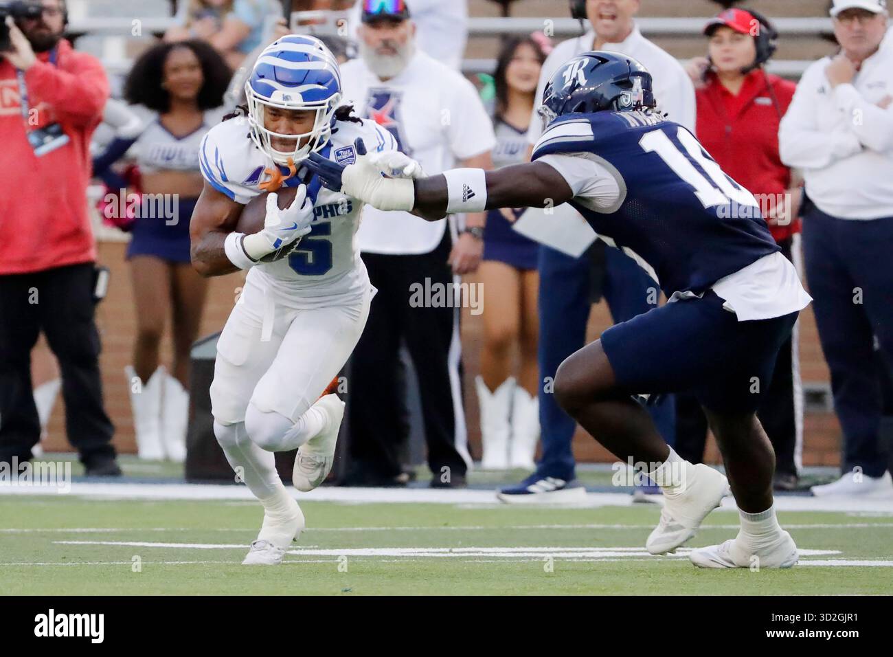 Memphis running back Sutton Smith, left, breaks the tackle attempt by ...