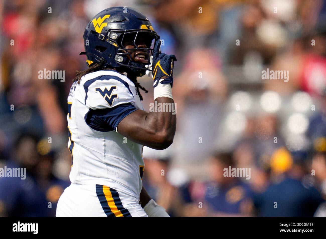 West Virginia safety Fred Perry reacts after sacking Houston ...