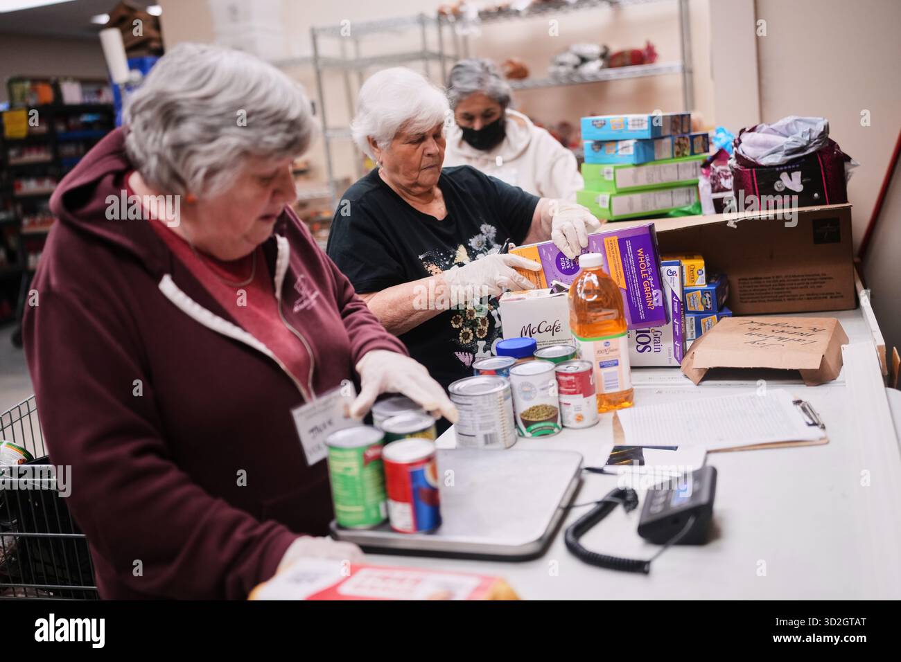 Volunteers Jackie Feichtinger, left, and Barbara Van Ornum, center, sort donations at the ...