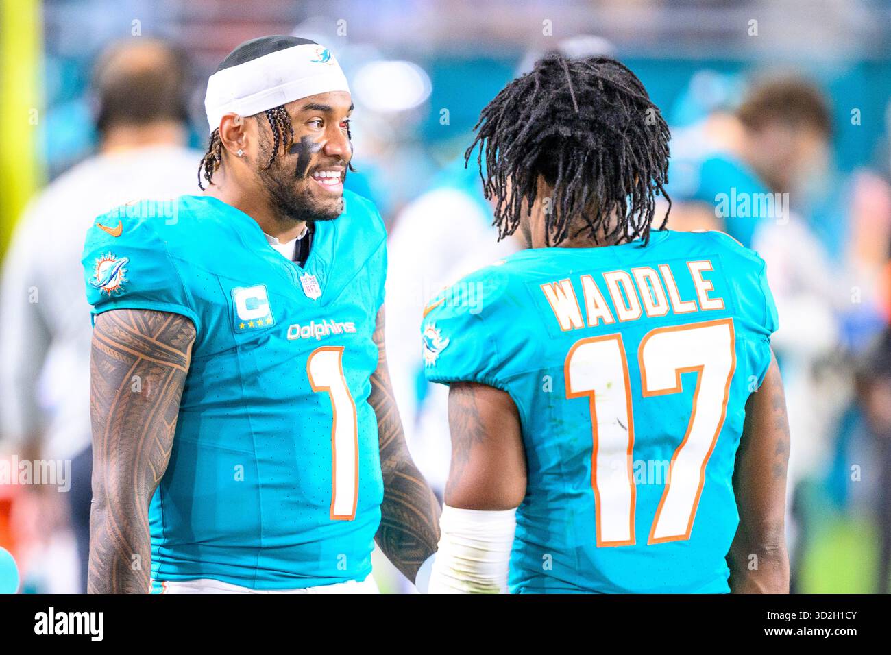 Miami Dolphins quarterback Tua Tagovailoa (1) talks to wide receiver ...