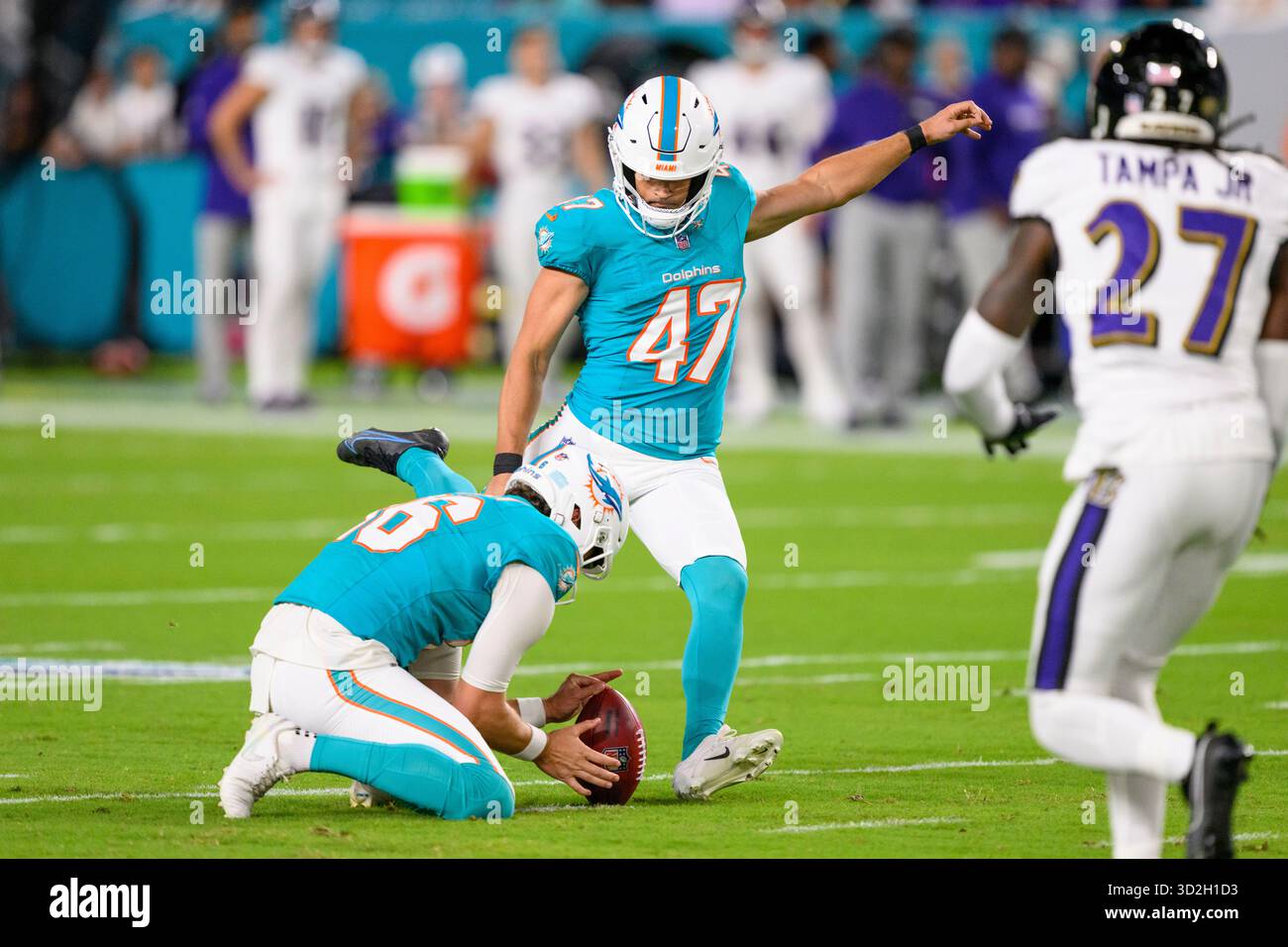 Miami Dolphins punter Jake Bailey (16) holds the ball as kicker Riley ...