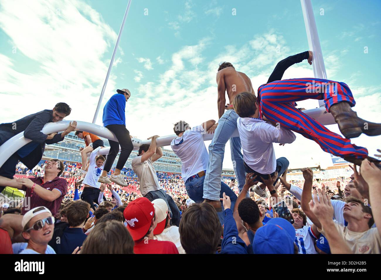 DALLAS, TX - NOVEMBER 01: Several SMU Mustangs fans hang off the goal ...