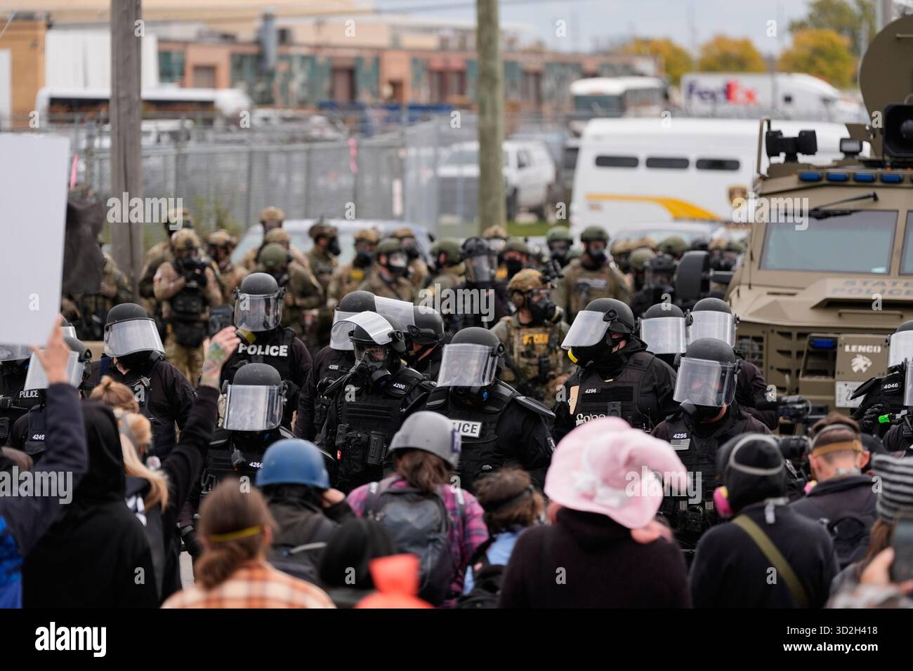 Law enforcement officers line up as protesters gather outside an ICE ...