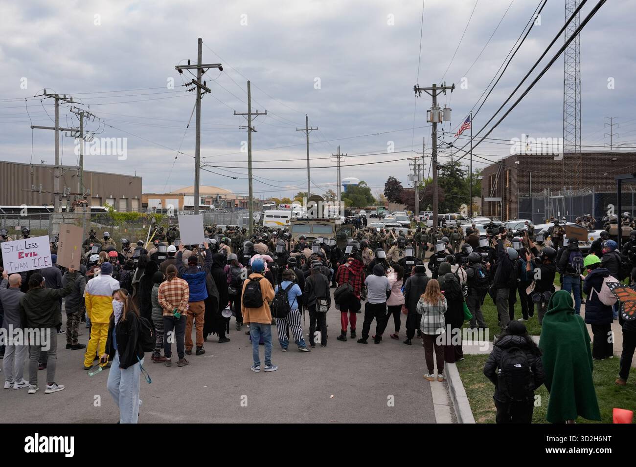 Law enforcement officers line up as protesters gather outside an ICE ...