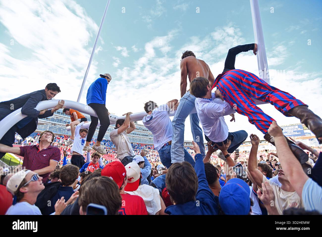 November 01, 2025: Several SMU Mustangs fans hang off the goal post ...