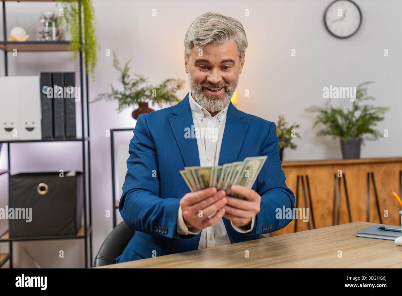 Happy middle aged businessman counting hi-res stock photography and ...
