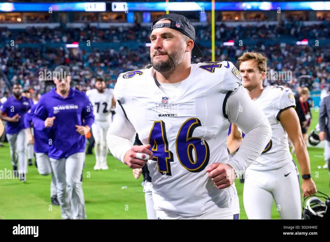Baltimore Ravens long snapper Nick Moore (46) runs off of the field ...