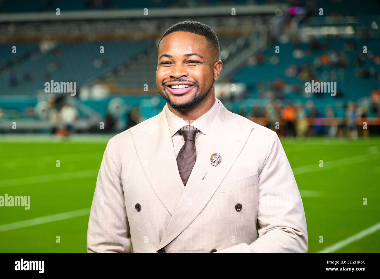 NFL Network reporter Cameron Wolf smiles as he prepares to go on the ...