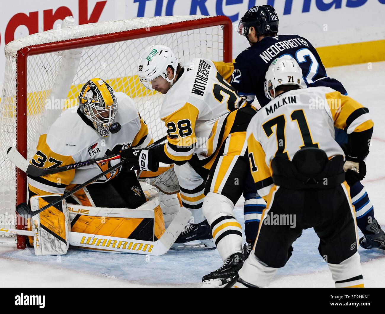 Winnipeg Jets' Nino Niederreiter's (62) shot goes off the mask of ...