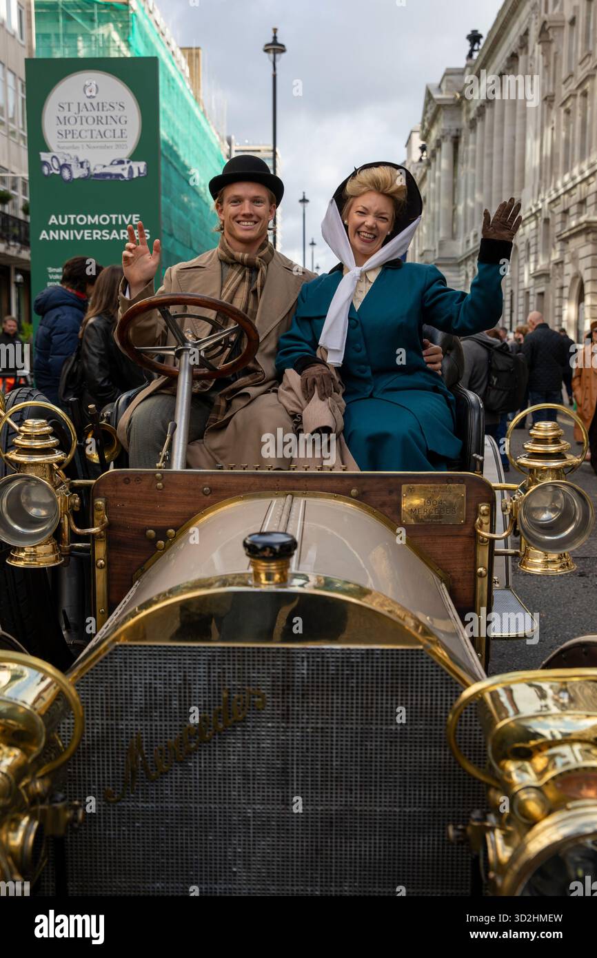 A gentlemen a Lady wearing traditional driving clothes sit in a vintage ...