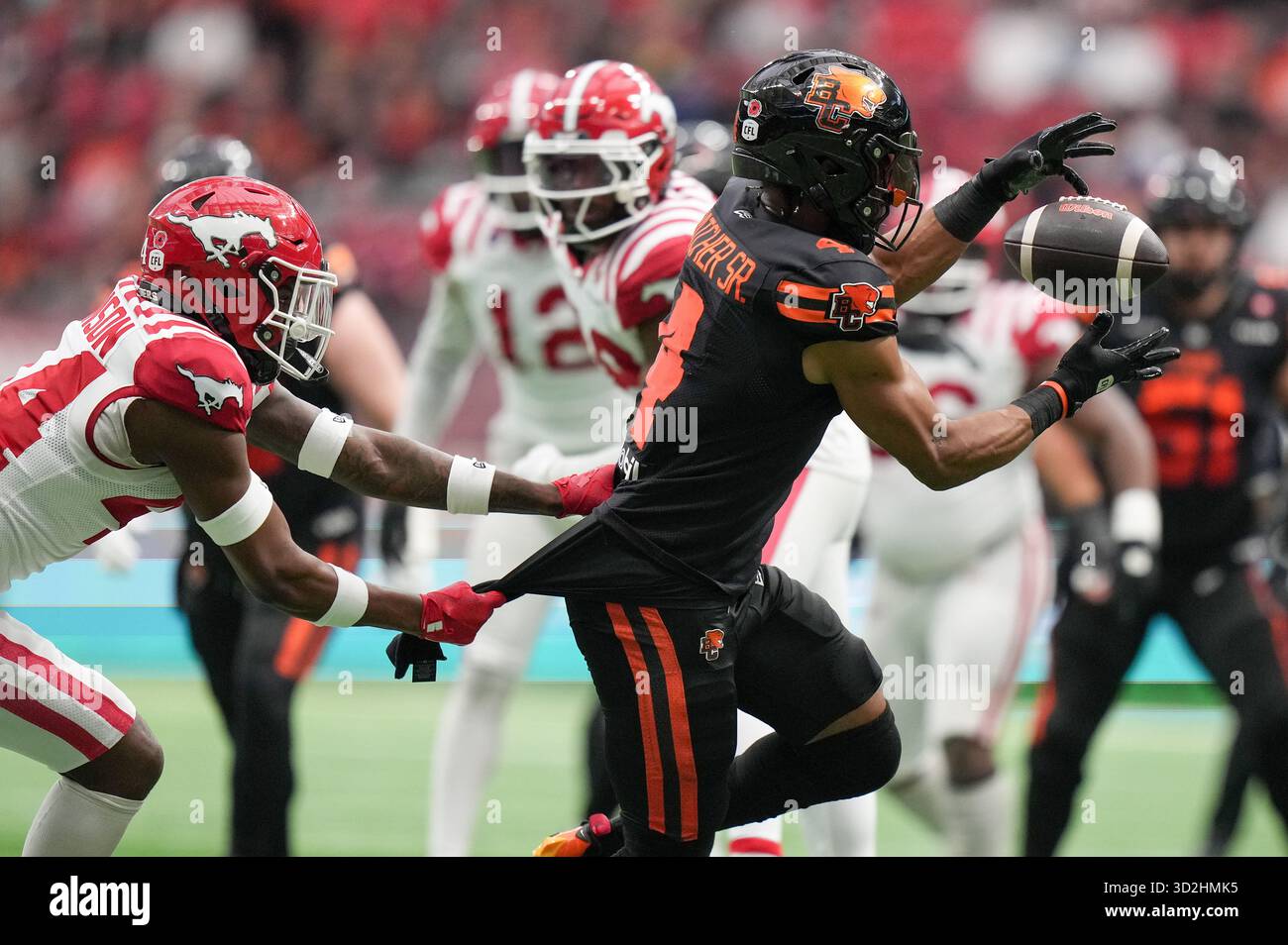 B.C. Lions' Keon Hatcher, right, makes a reception while being grabbed ...