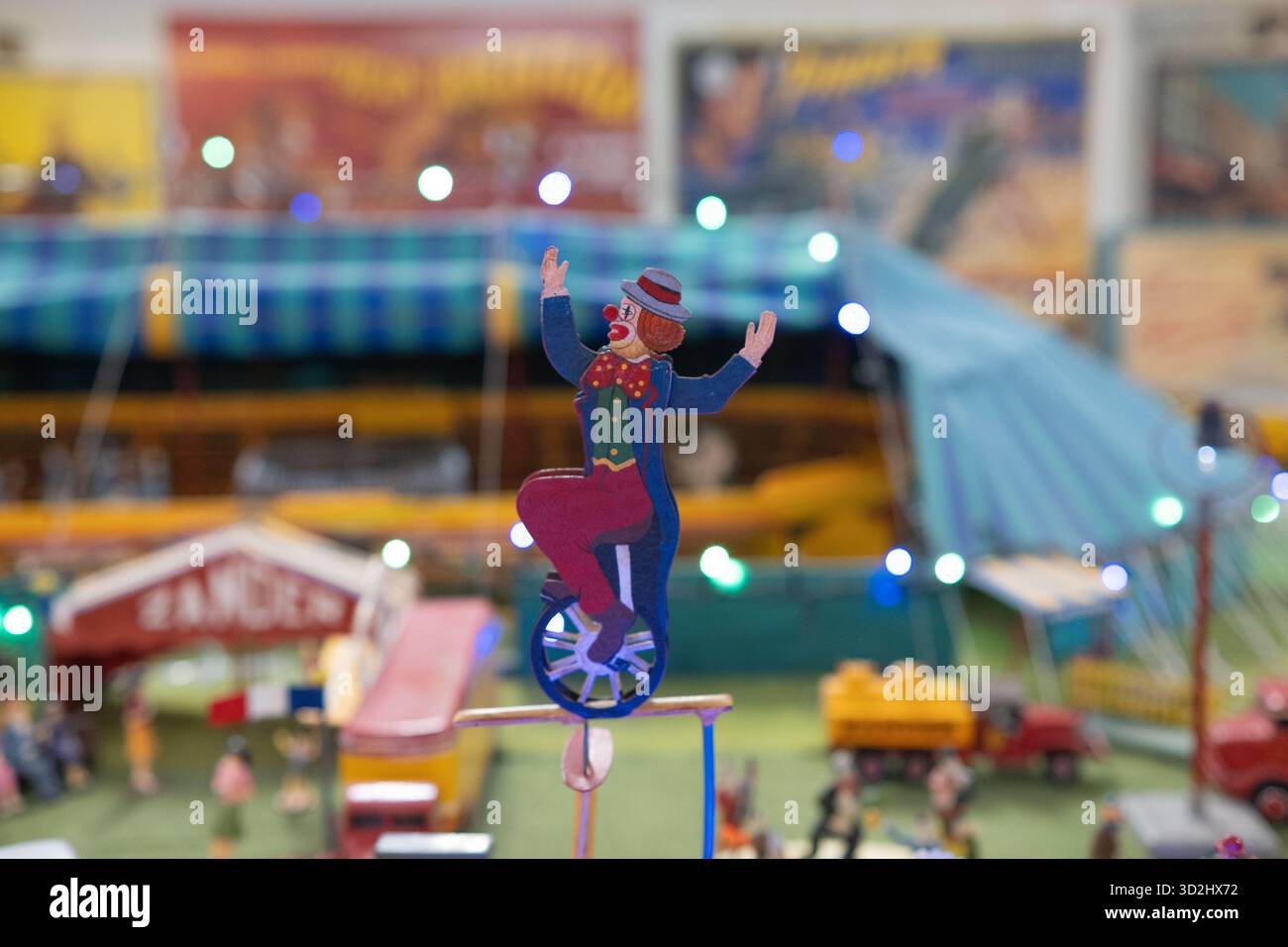 Vintage circus miniature with clown on unicycle Stock Photo - Alamy