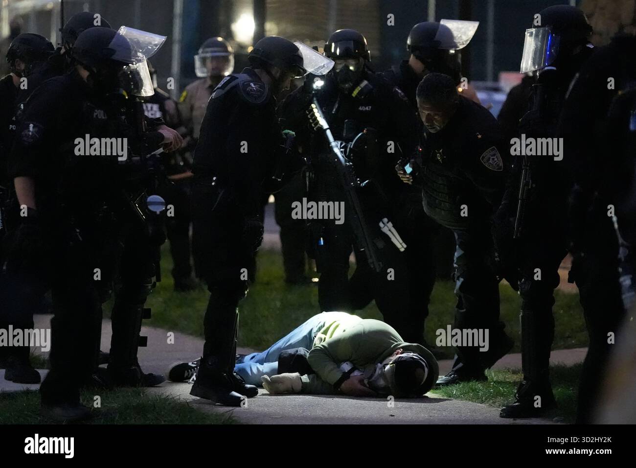 Law enforcement officers check on a protestor after pushing the crowd ...