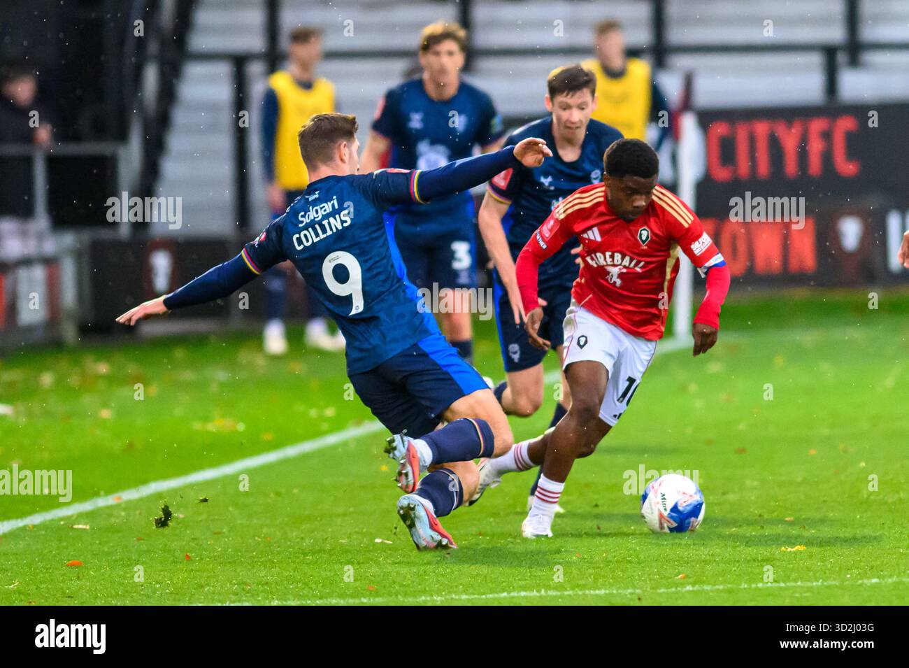 James Collins of Lincoln City FC tackles Kelly Nmai of Salford City FC ...