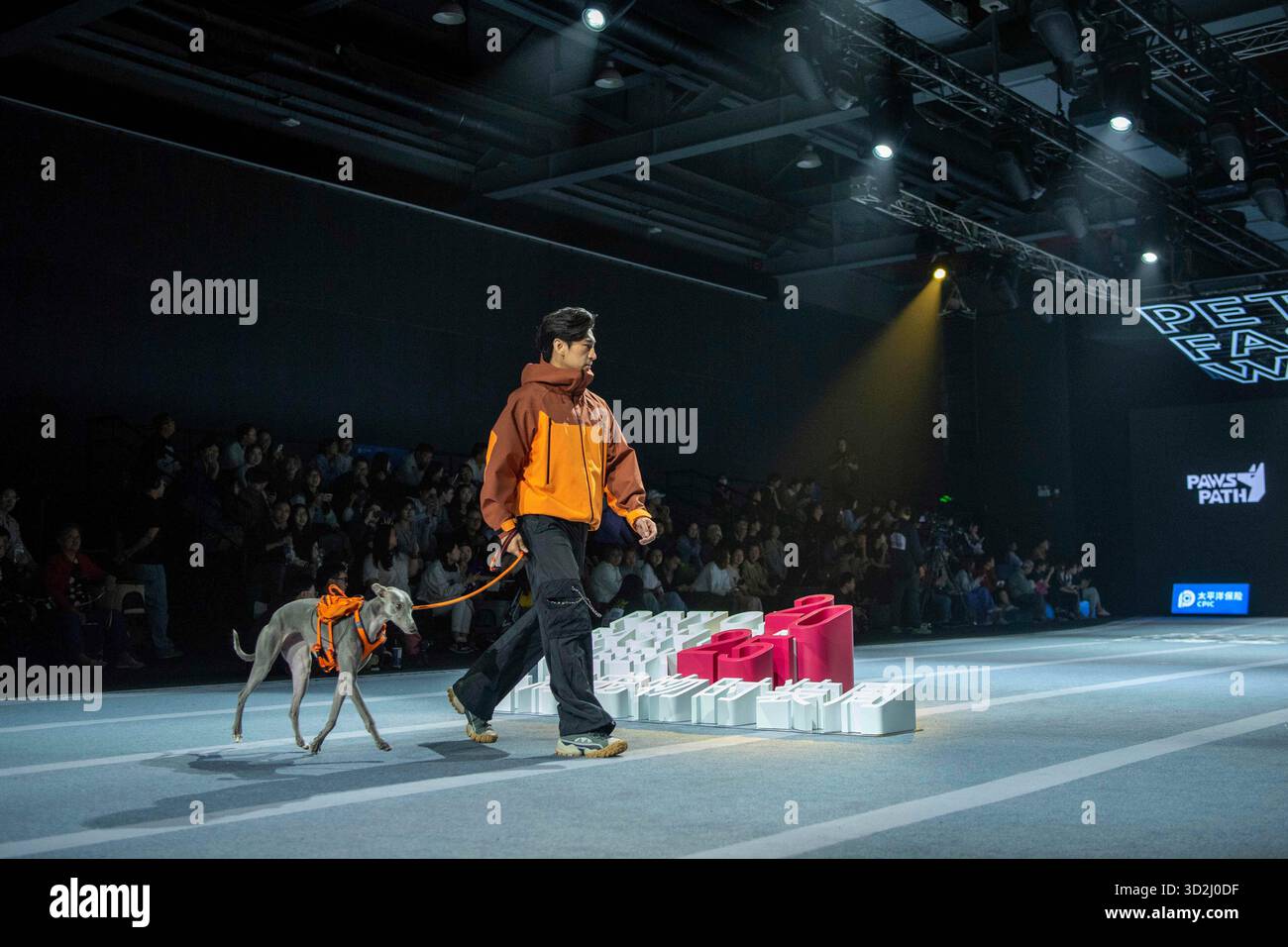 People present their dressed-up pets on the catwalk during Shanghai Pet ...
