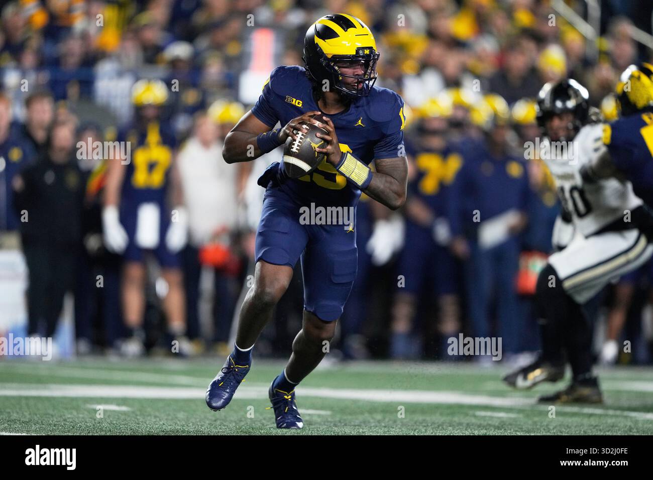 Michigan quarterback Bryce Underwood (19) runs from pressure during the first half of an NCAA ...
