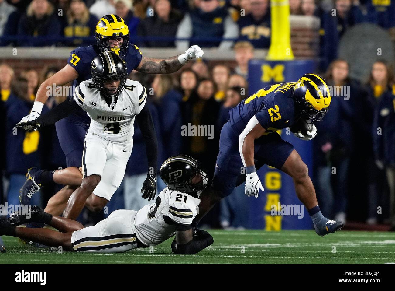 Michigan running back Jordan Marshall (23) is tackled by Purdue ...