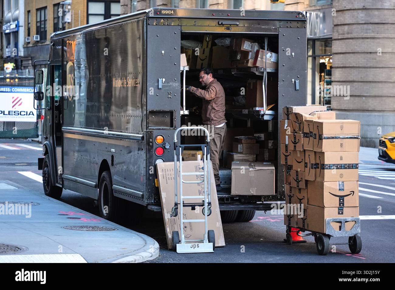 A UPS driver makes a deliveries in the Financial District of New York ...