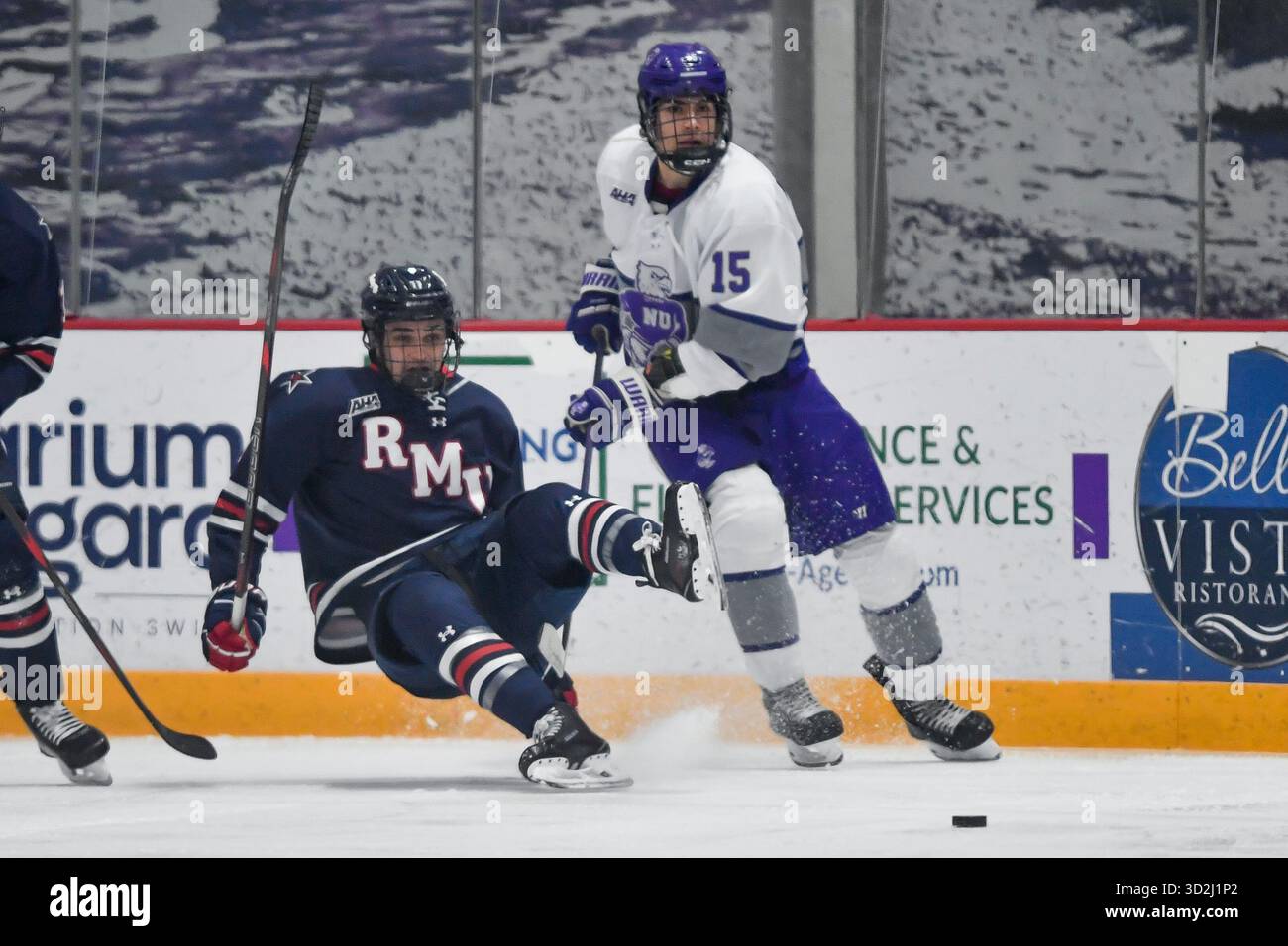Robert Morris left wing Dario Beljo, left, goes to the ice as he vies ...