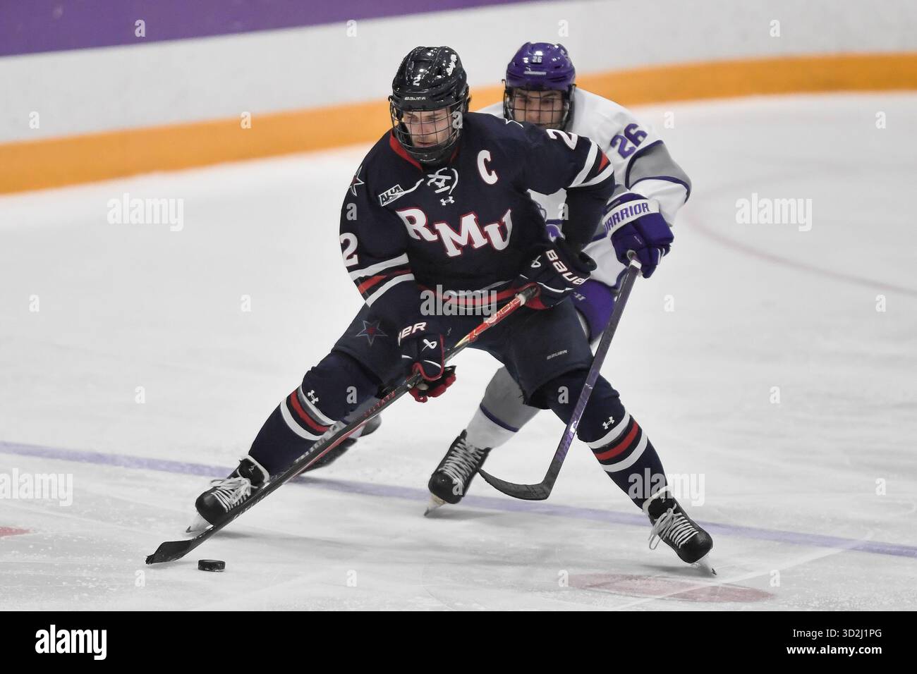 Robert Morris defenseman Michael Craig, left, shields the puck from ...