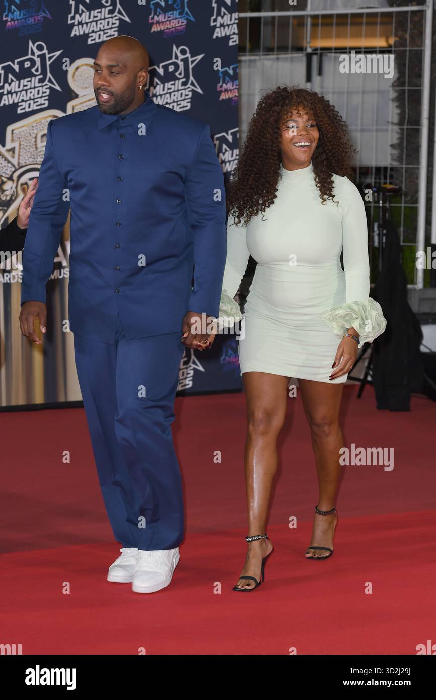 Teddy Riner and Luthna Plocus attend the Photocall during the 27th NRJ ...
