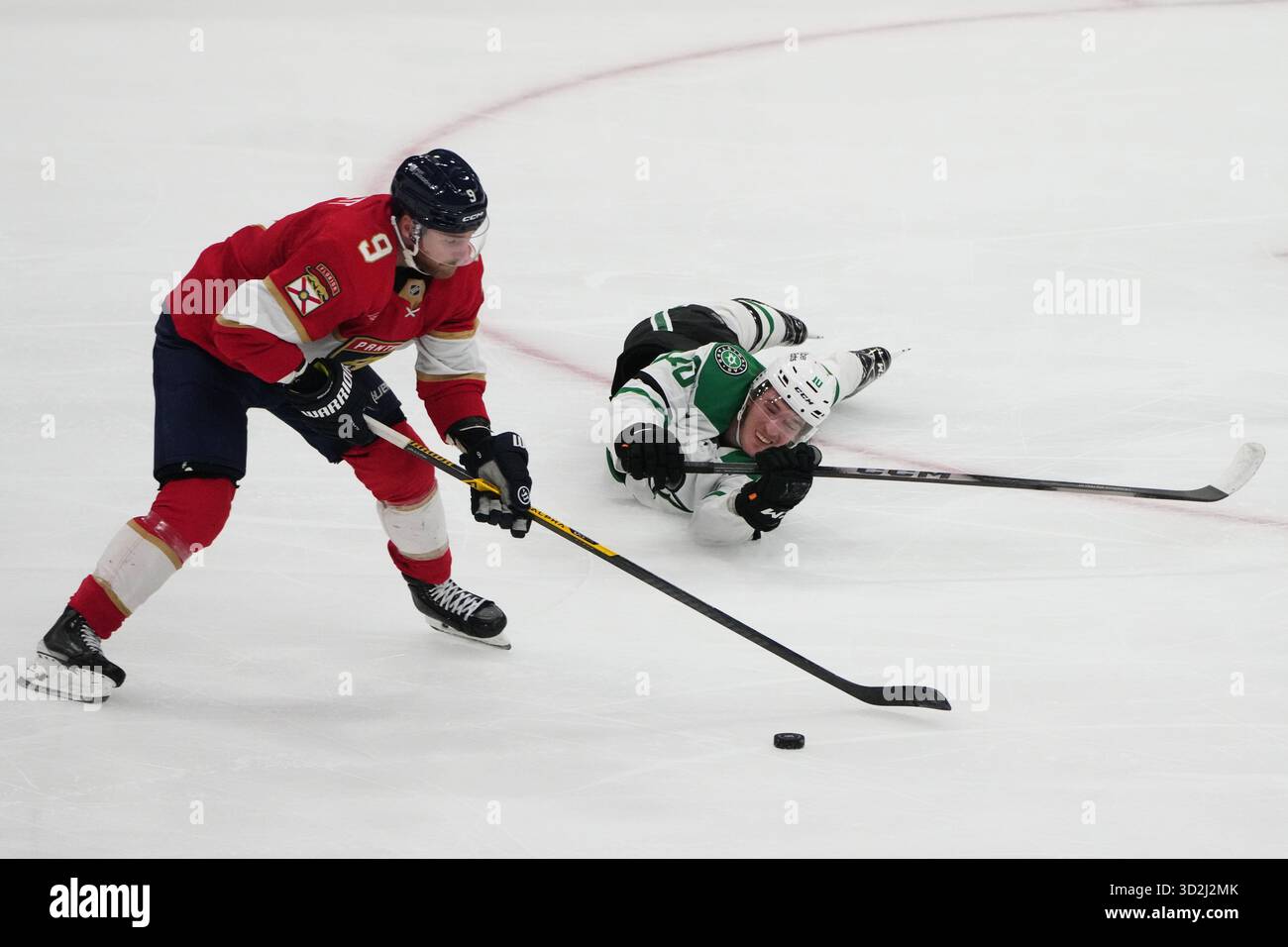 Dallas Stars center Oskar Back, right, falls to the ice as he goes for ...