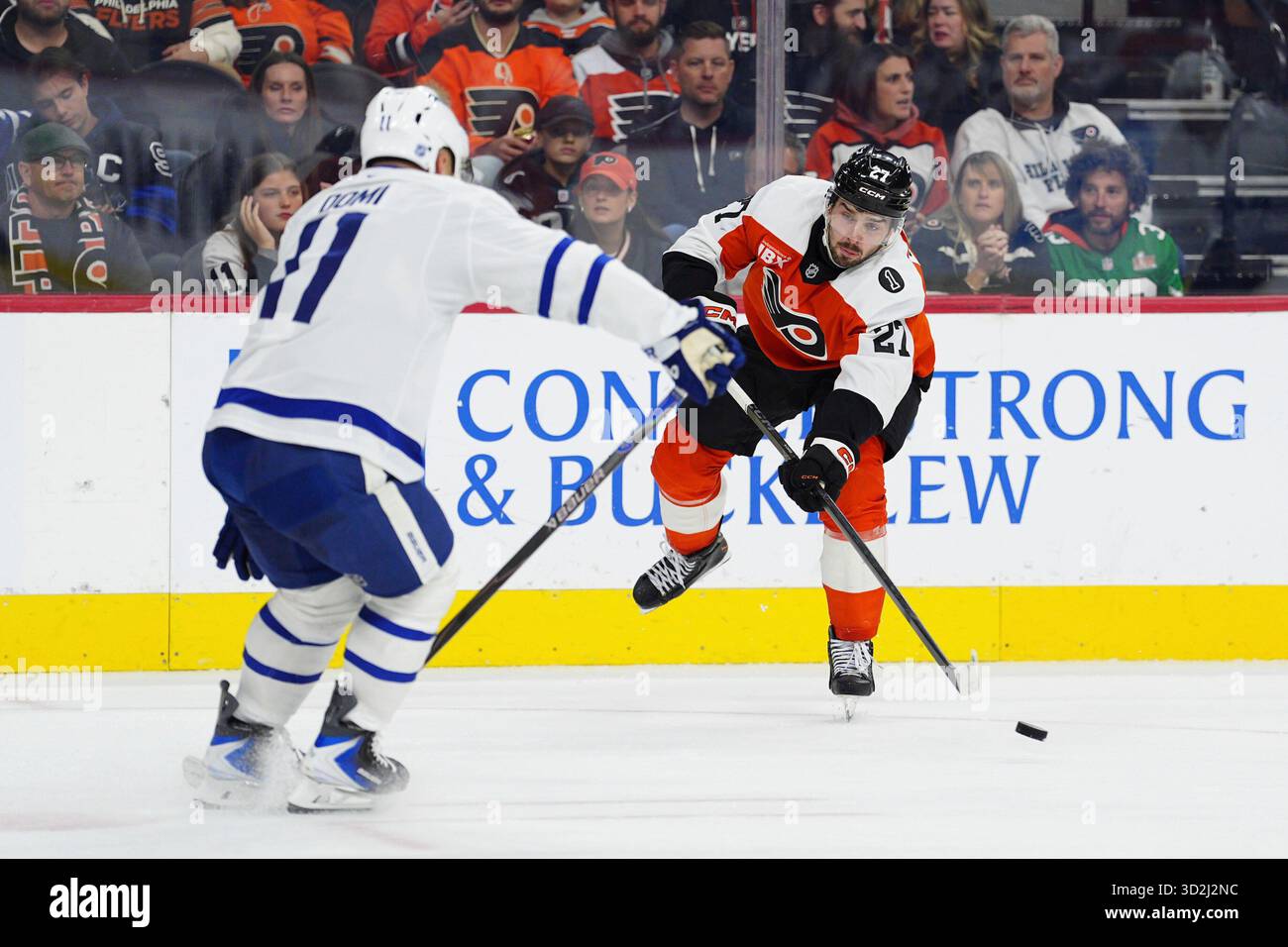 Philadelphia Flyers' Noah Cates, right, takes a shot against Toronto ...