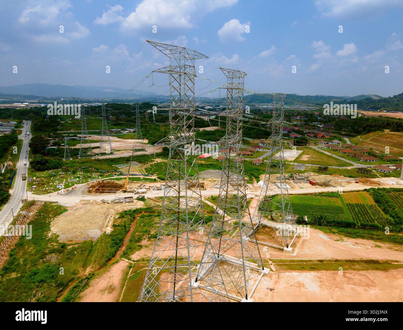 Aerial and ground view of high-voltage transmission towers in rural ...