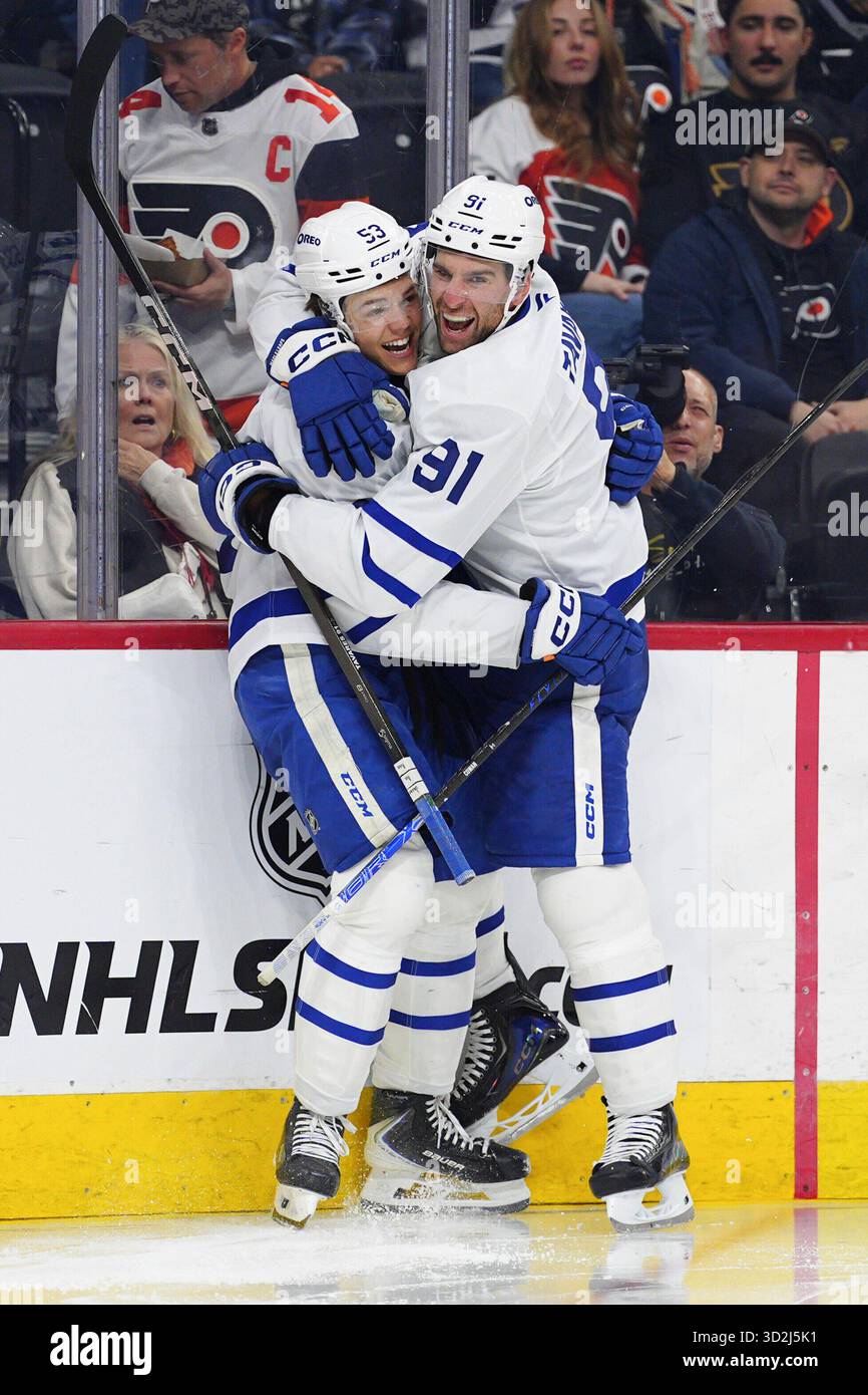 Toronto Maple Leafs' Easton Cowan, left, celebrates his goal with John ...