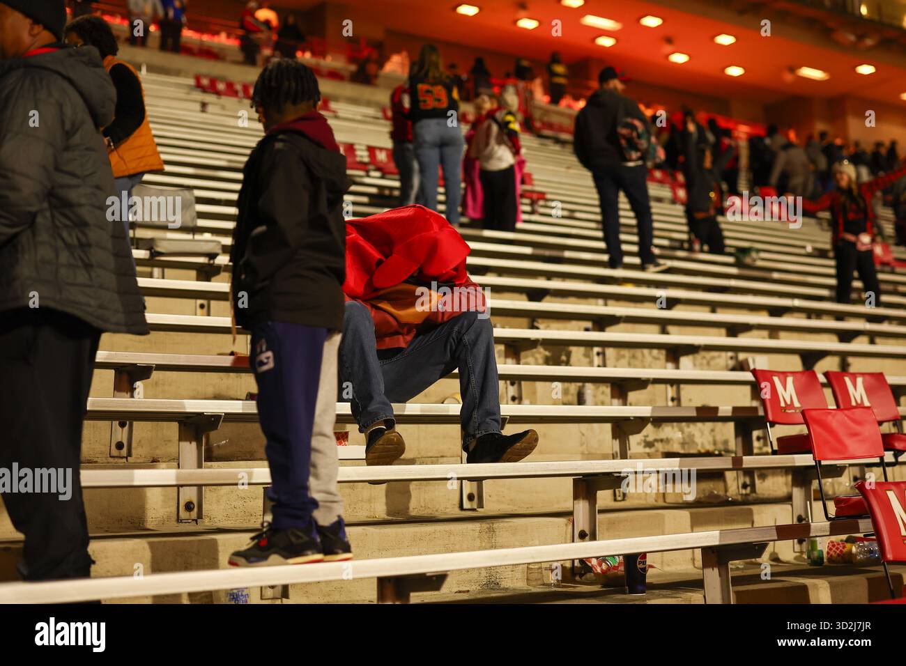 College Park, MD: A Maryland Terrapins fan sits dejected after the NCAA ...