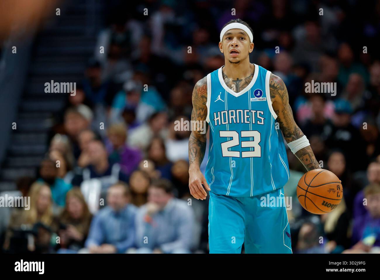 Charlotte Hornets guard Tre Mann brings the ball upcourt during the second half of an NBA ...