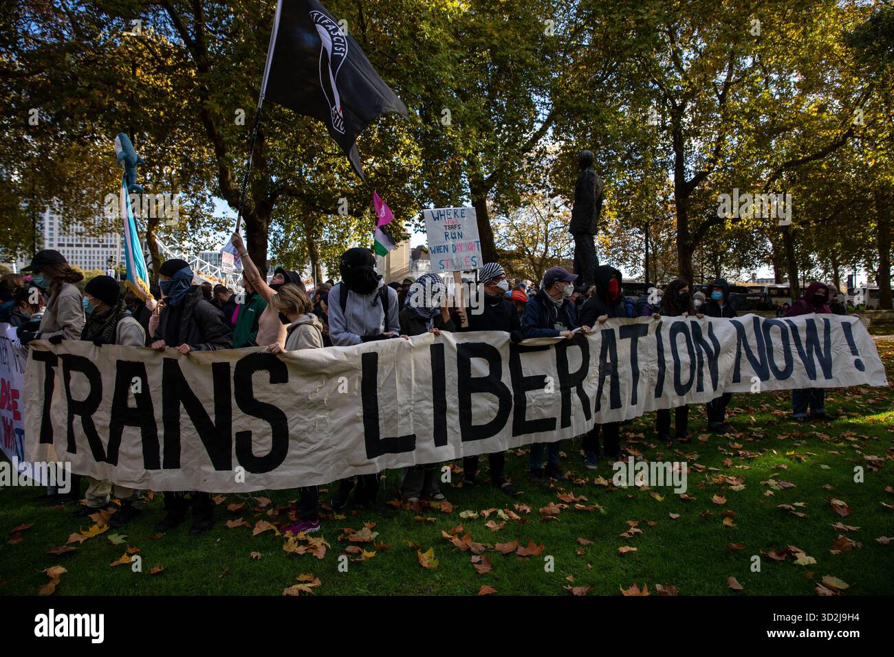 Trans activists hold a banner during a demonstration. Trans activists ...