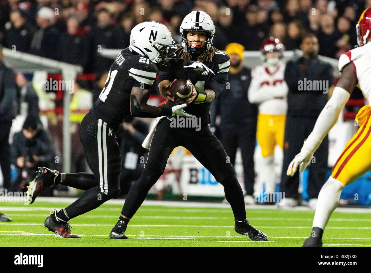 Nebraska quarterback TJ Lateef (14) hands off the ball to running back ...