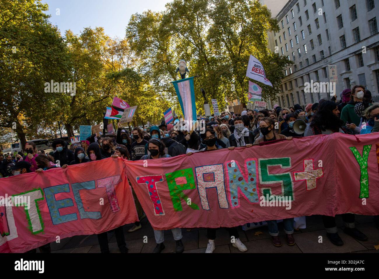 Trans activists hold a banner during a demonstration. Trans activists ...