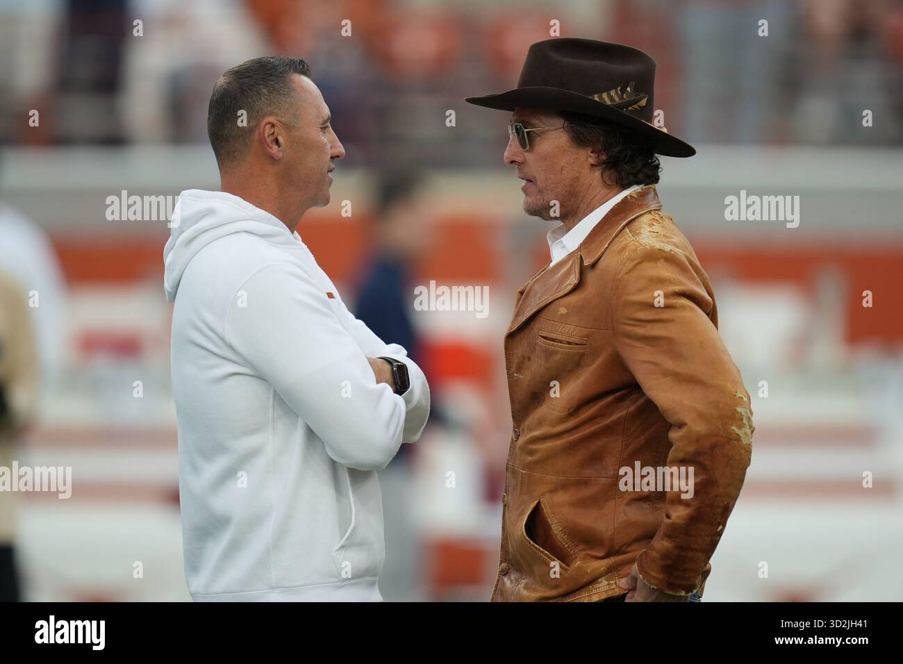 Texas head coach Steve Sarkisian, left, talks with actor Matthew ...