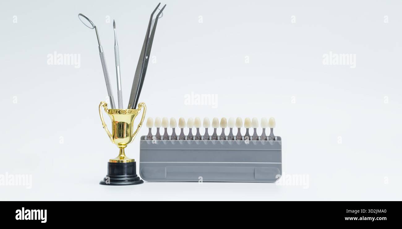 A golden dental trophy holding instruments is displayed next to a tooth ...