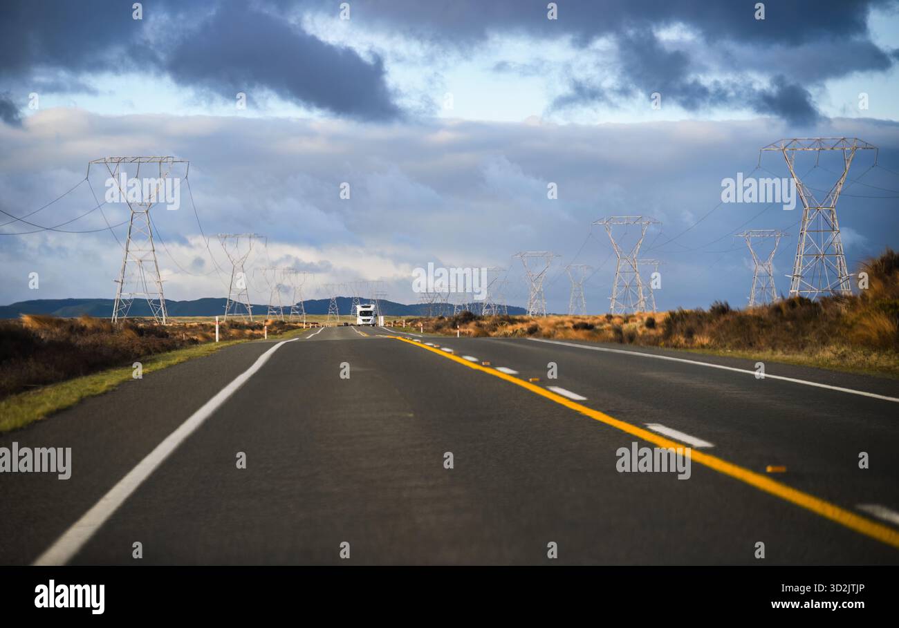 Power pylons and power lines on both sides of the Desert Road. Truck ...