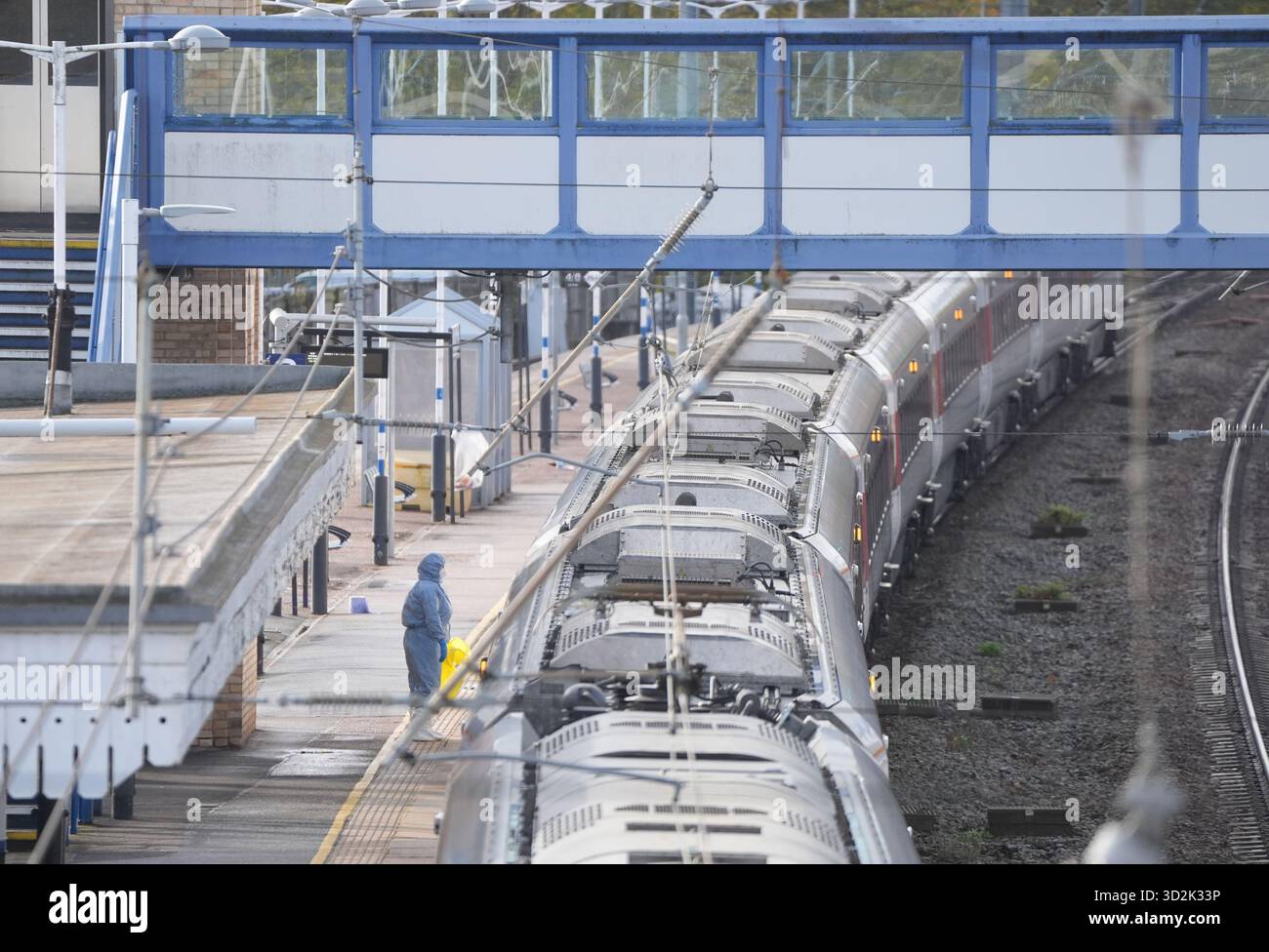 A forensic investigator on the platform by the train at Huntingdon ...