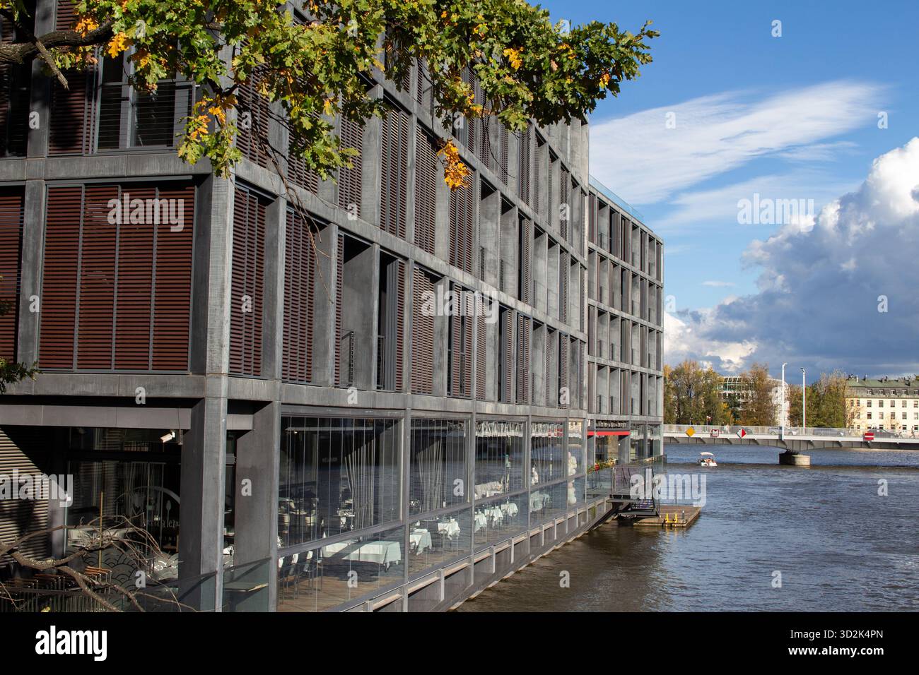 Modern riverside building reflects contemporary architecture in a ...