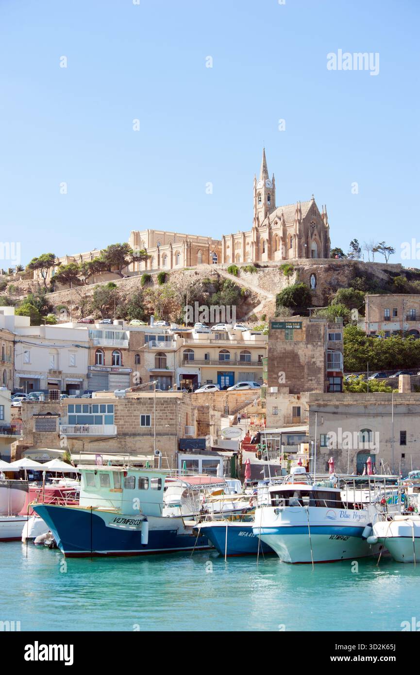 The pretty harbour of Mgarr overlooked by Our Lady of Lourdes Chapel ...