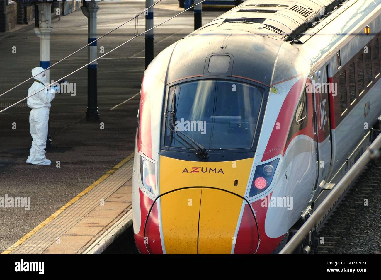 A forensic investigator takes pictures of the train after a mass ...